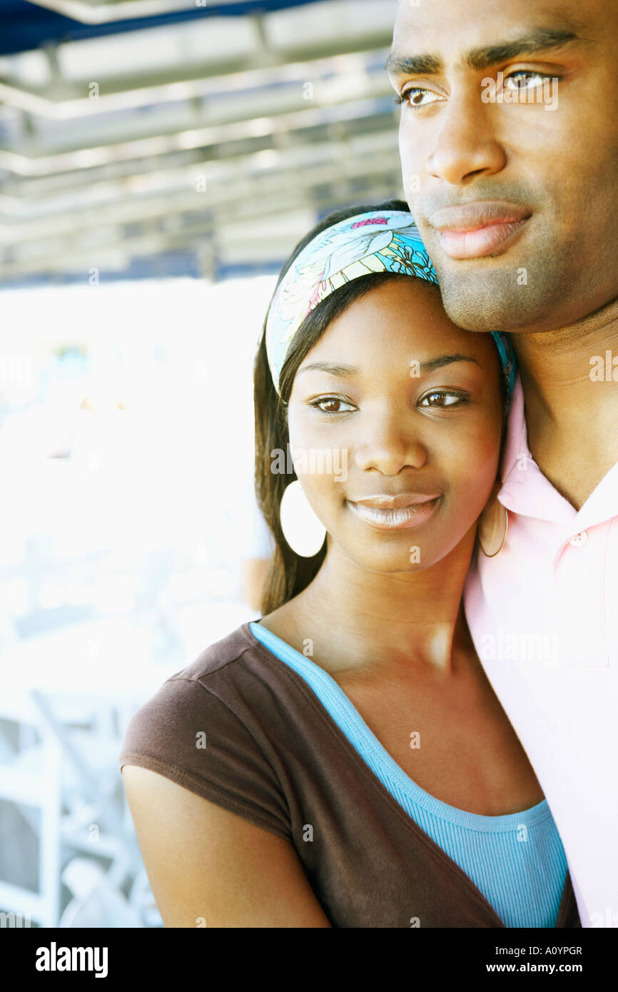 Young African couple hugging Stock Photo - Alamy