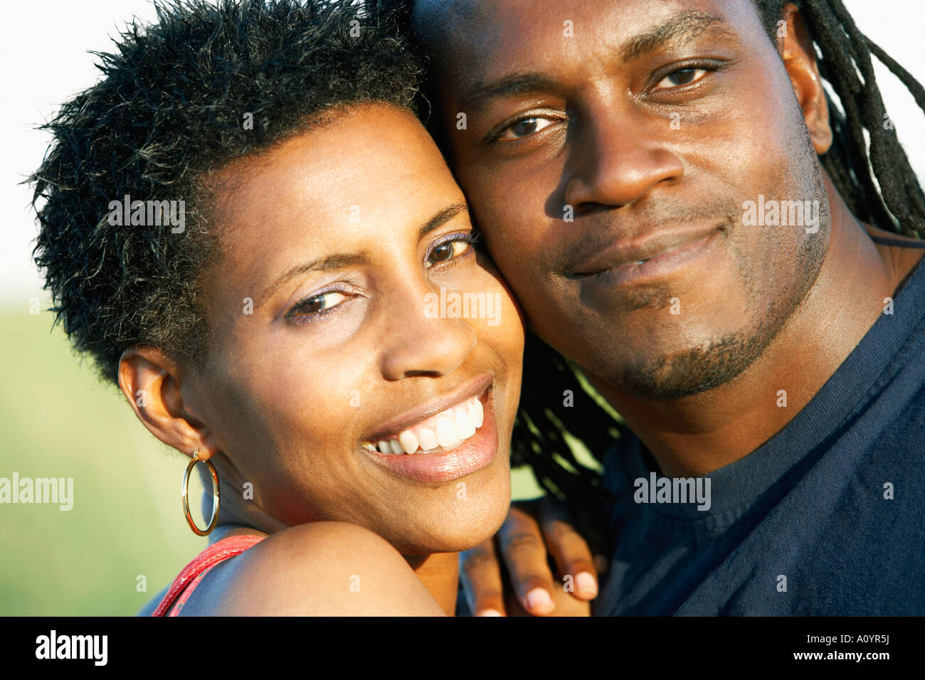 Young African couple smiling Stock Photo - Alamy