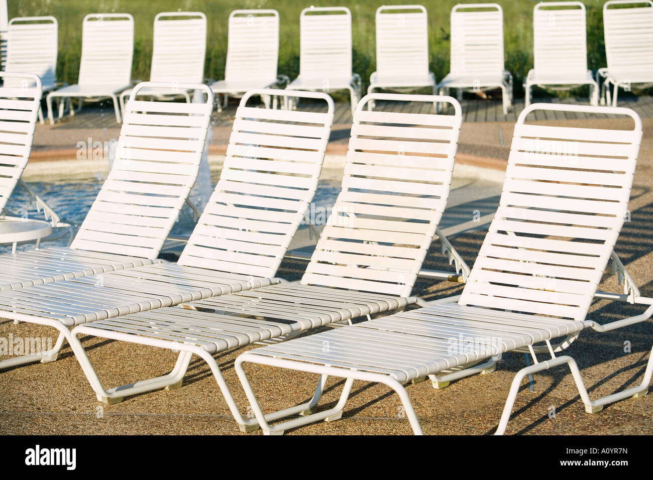 White lawn chairs on beach Stock Photo - Alamy