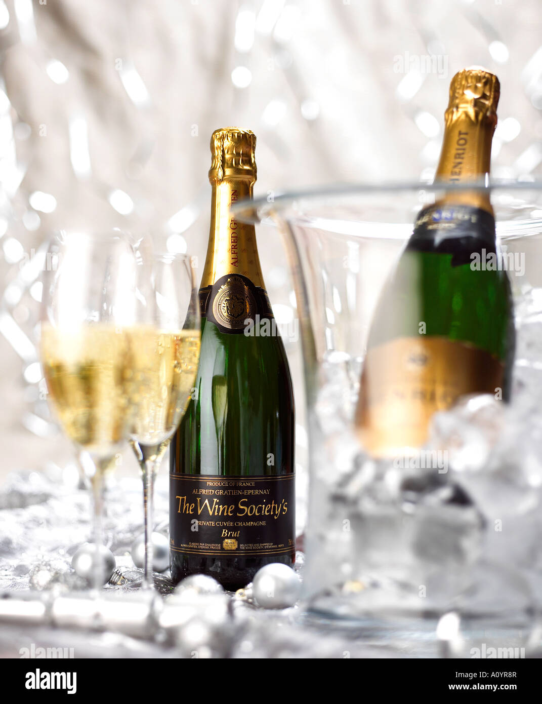 Two bottles of Champagne, one in bottle cooler. Two filled champagne ...