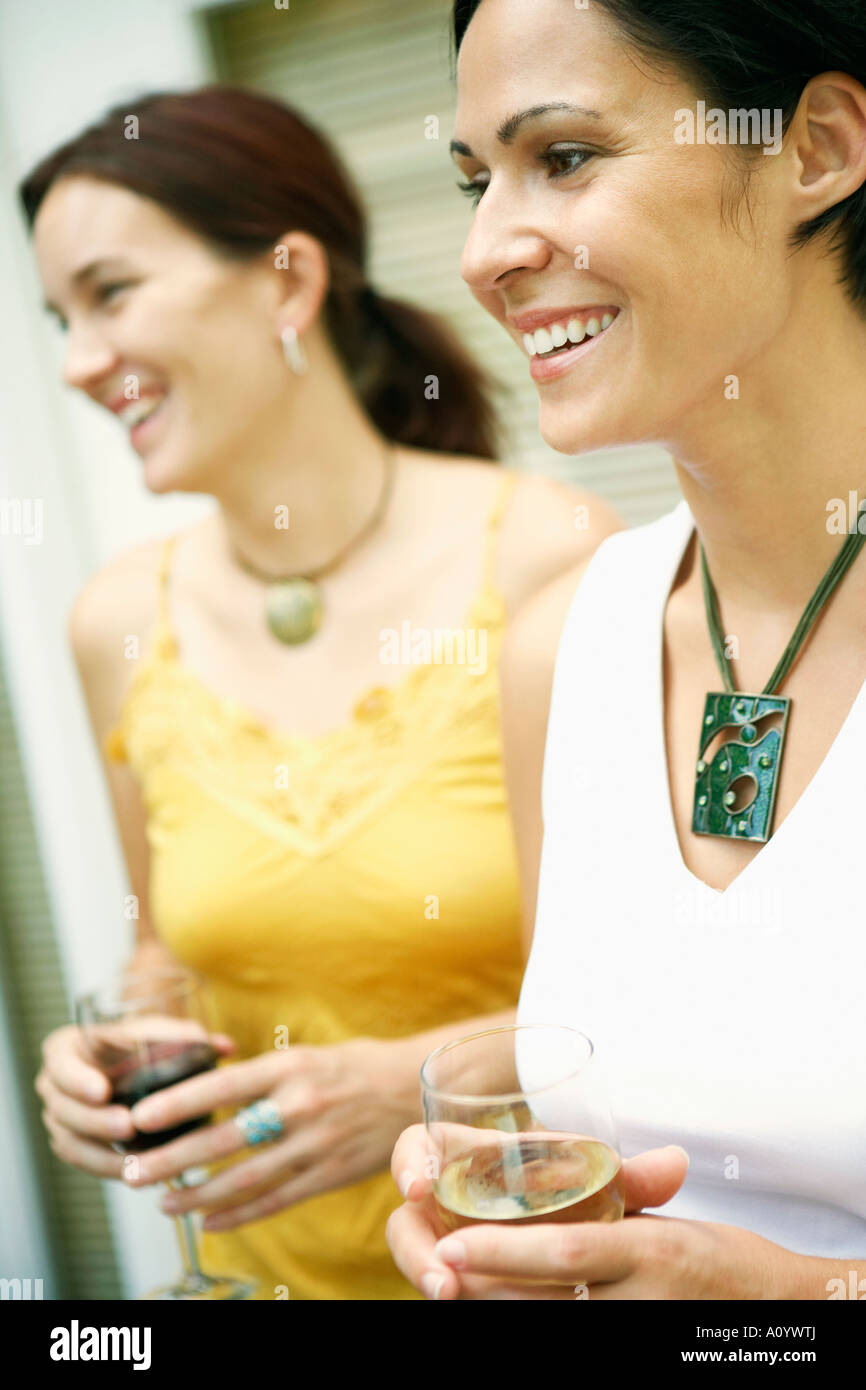 Young women drinking wine together Stock Photo - Alamy