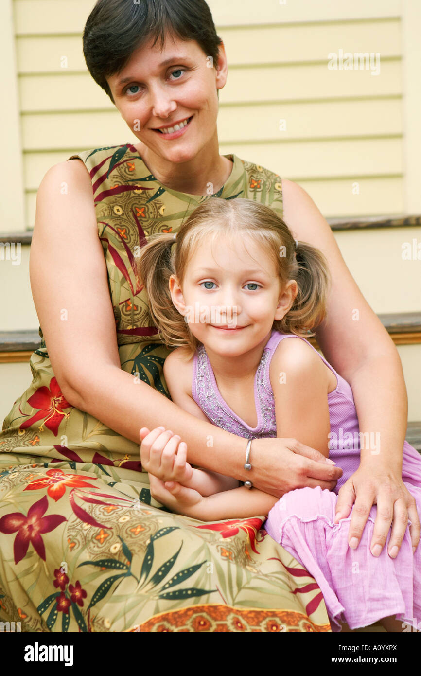 Young woman hugging her daughter Stock Photo - Alamy