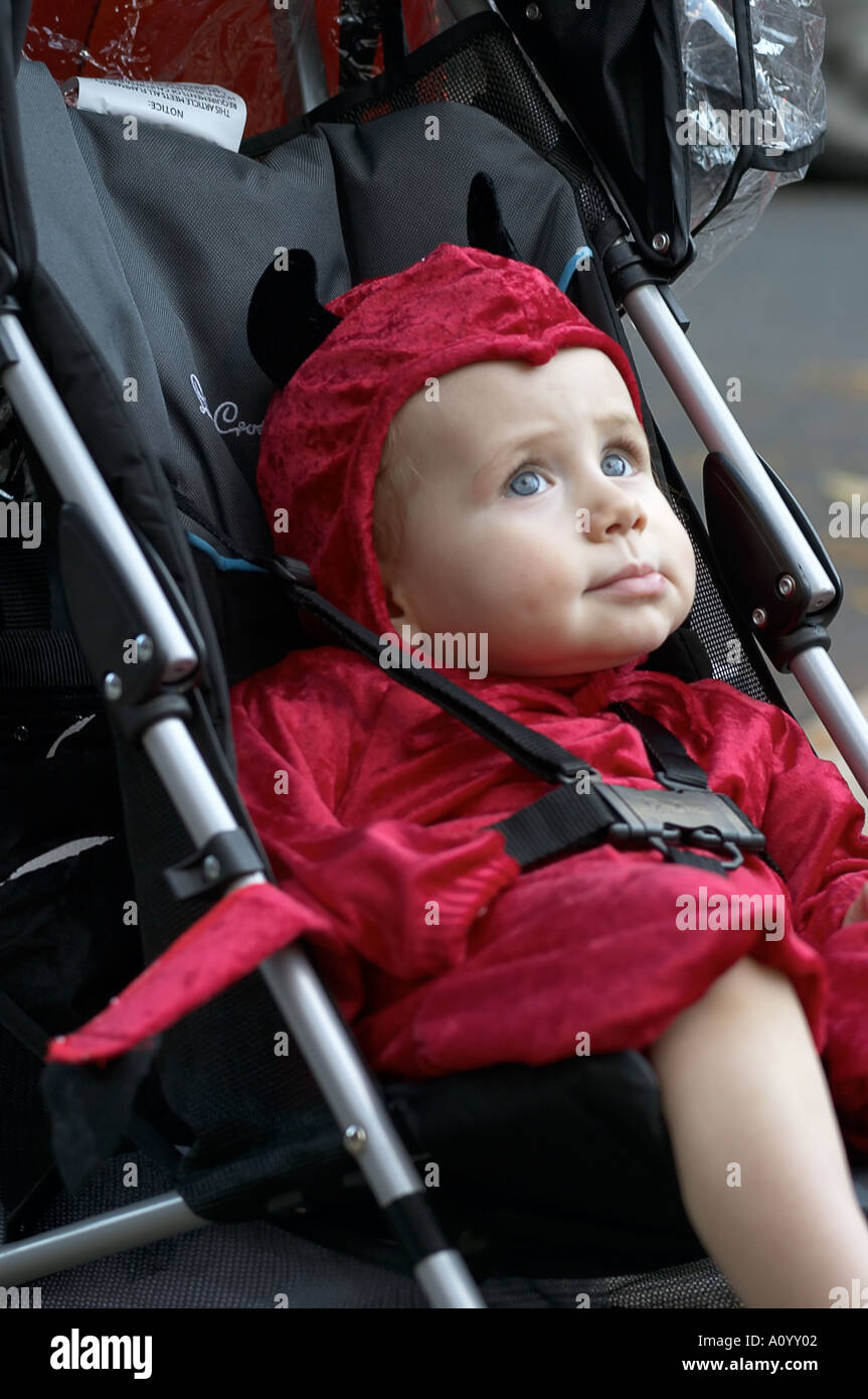 Baby in devil costume relaxes in stroller Model released and Property ...
