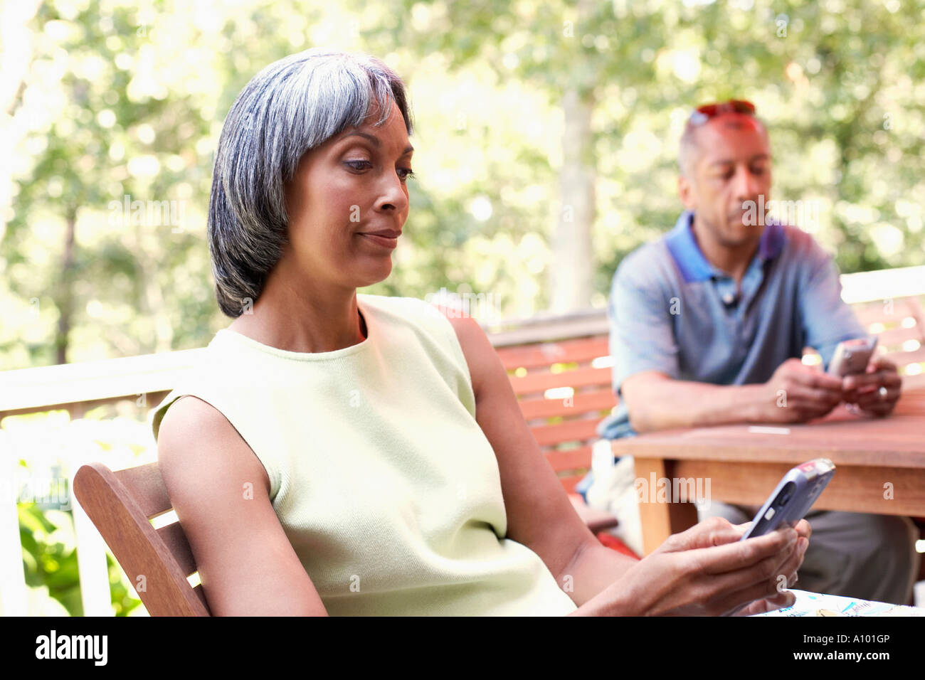 Middle-aged African woman using her cell phone Stock Photo - Alamy
