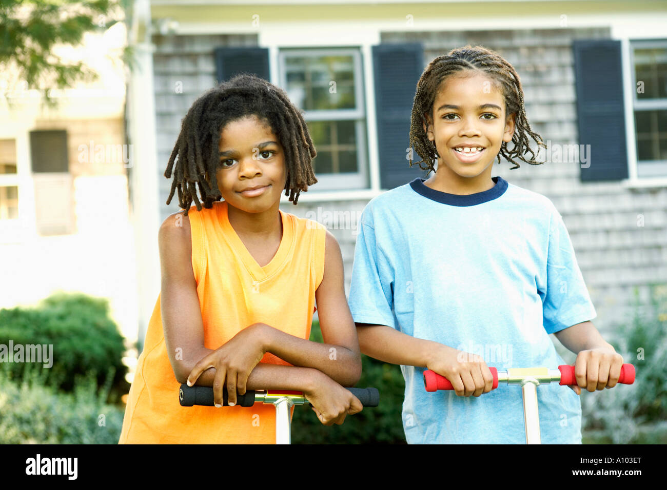 Young African boys riding scooters Stock Photo - Alamy