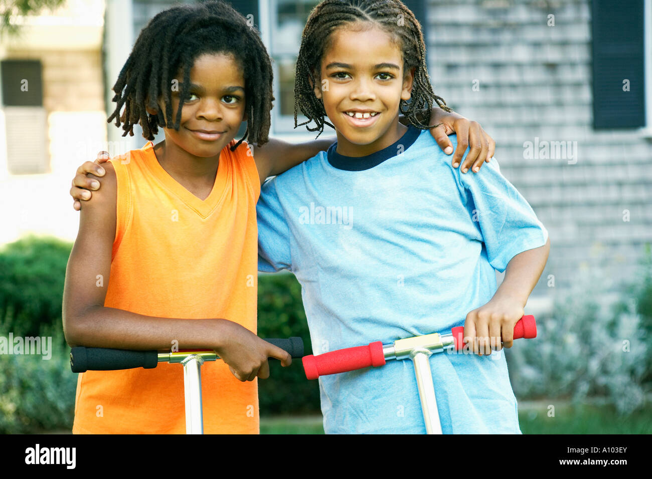 Young African boys riding scooters Stock Photo - Alamy