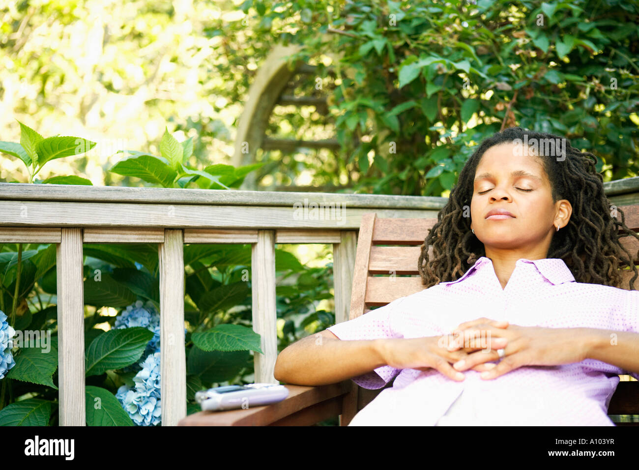 Young African woman relaxing outdoors Stock Photo - Alamy