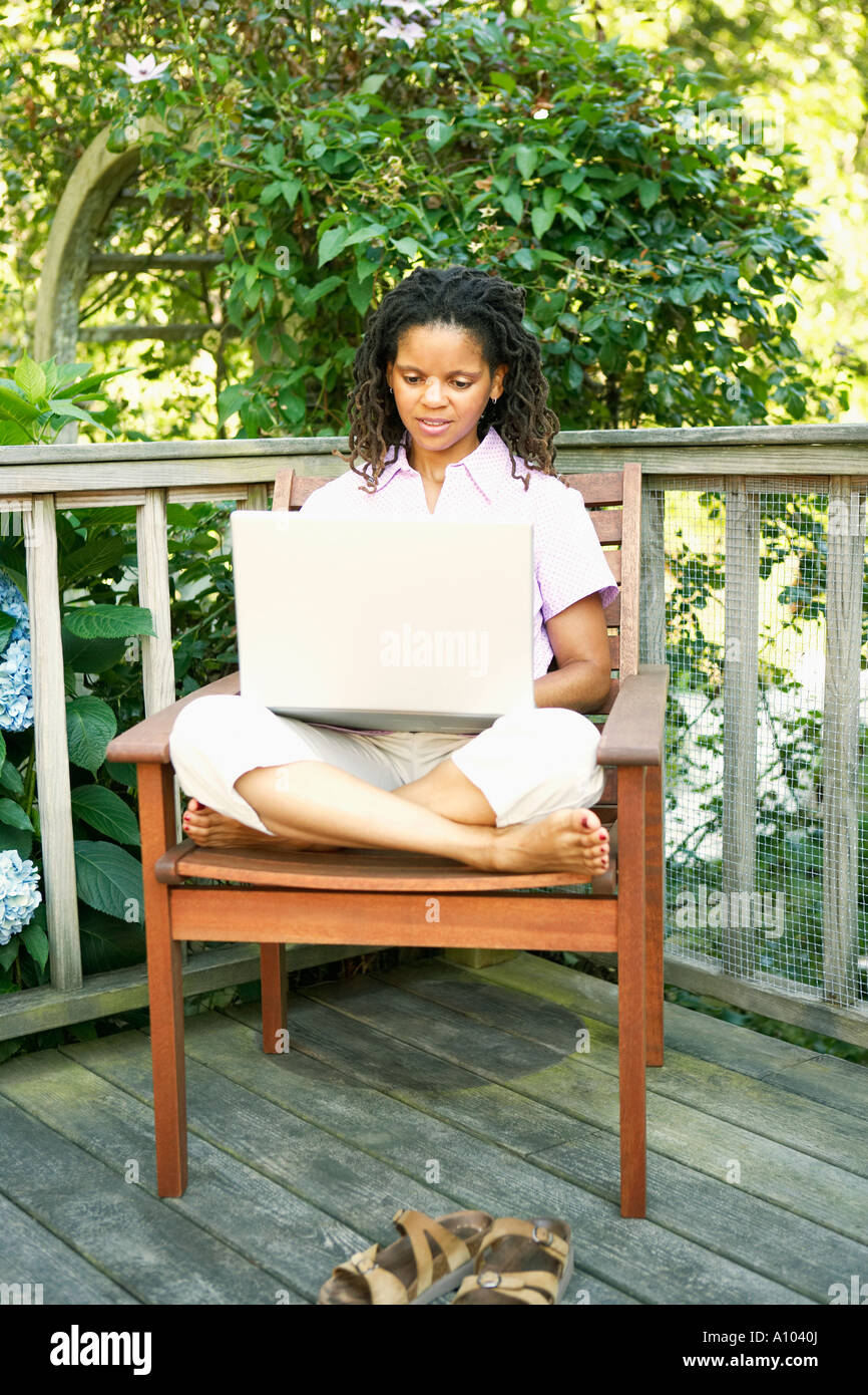 Young African woman using a laptop outdoors Stock Photo - Alamy