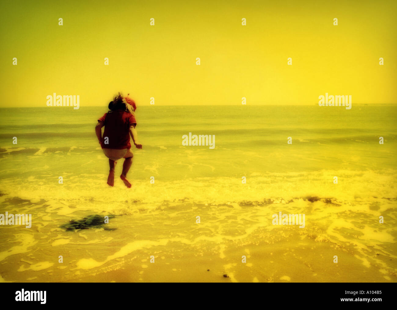 Child jumping over waves hi-res stock photography and images - Alamy