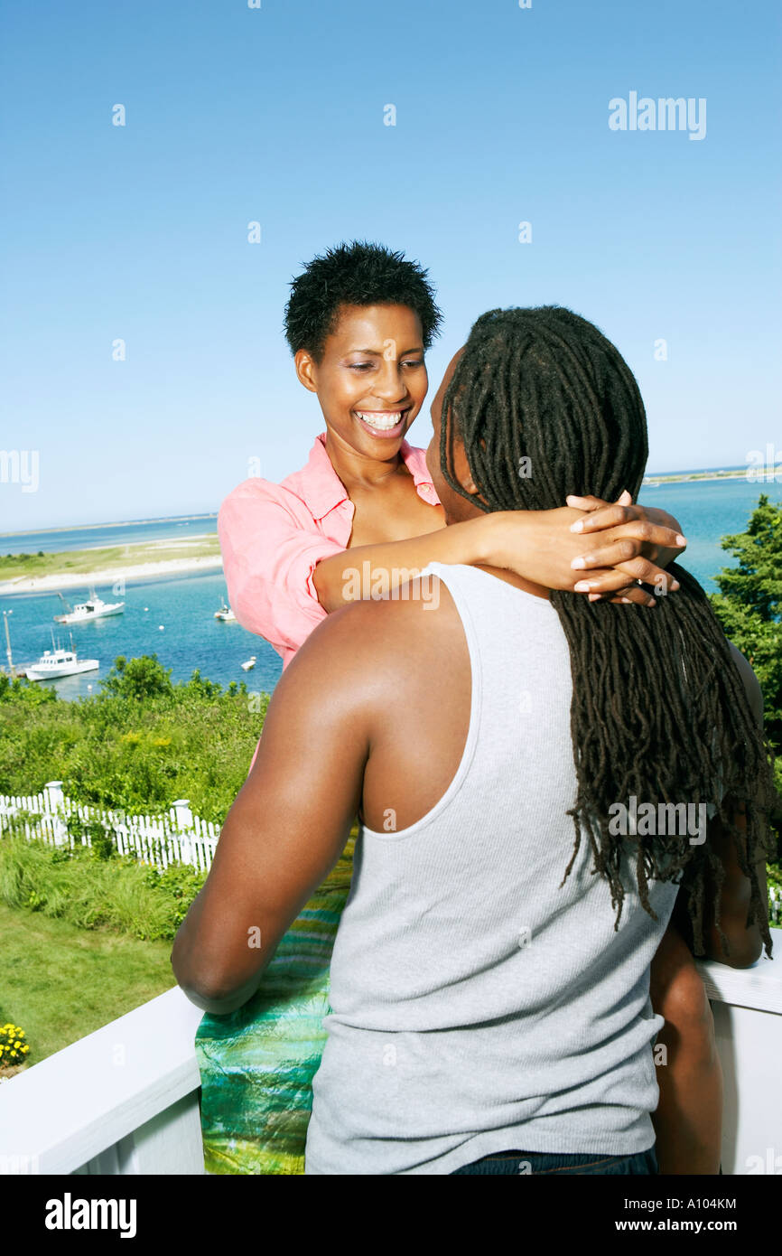 Young African couple hugging Stock Photo - Alamy