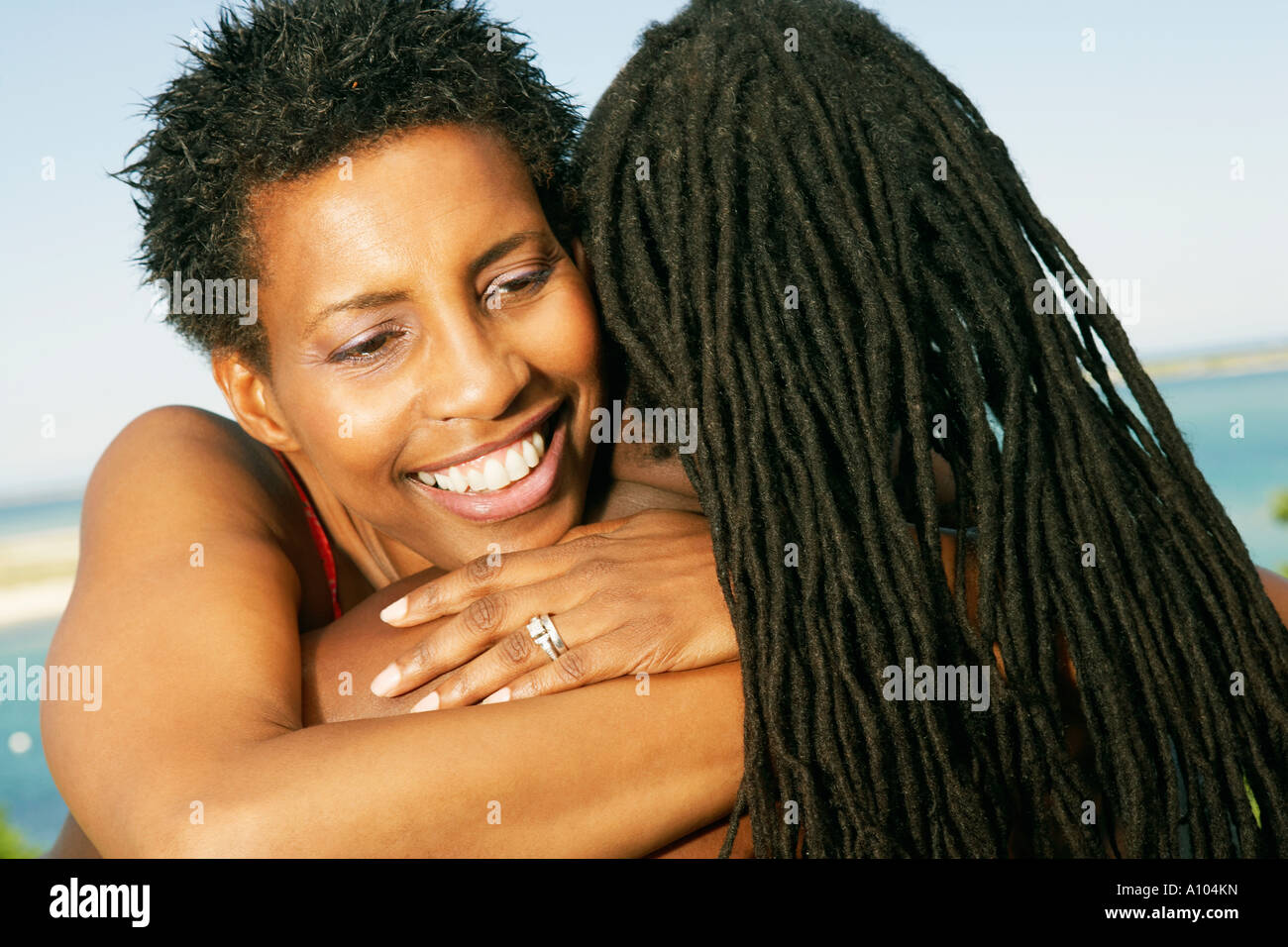 Young African couple hugging Stock Photo - Alamy