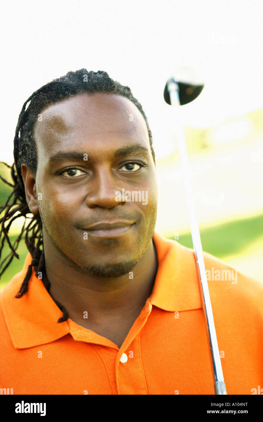 Young African man playing golf Stock Photo - Alamy