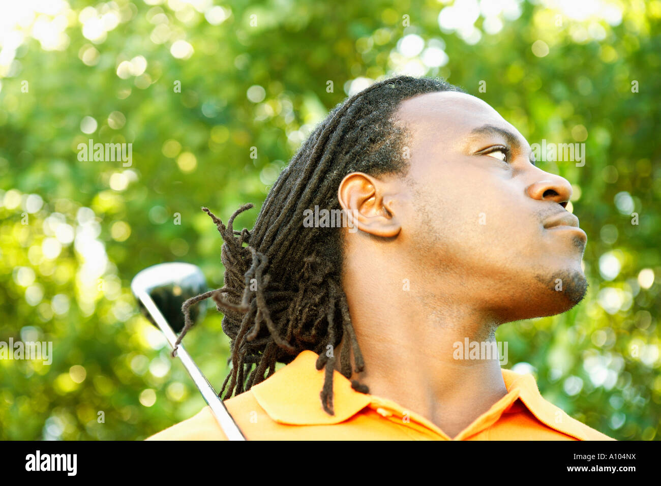 Young African man playing golf Stock Photo - Alamy