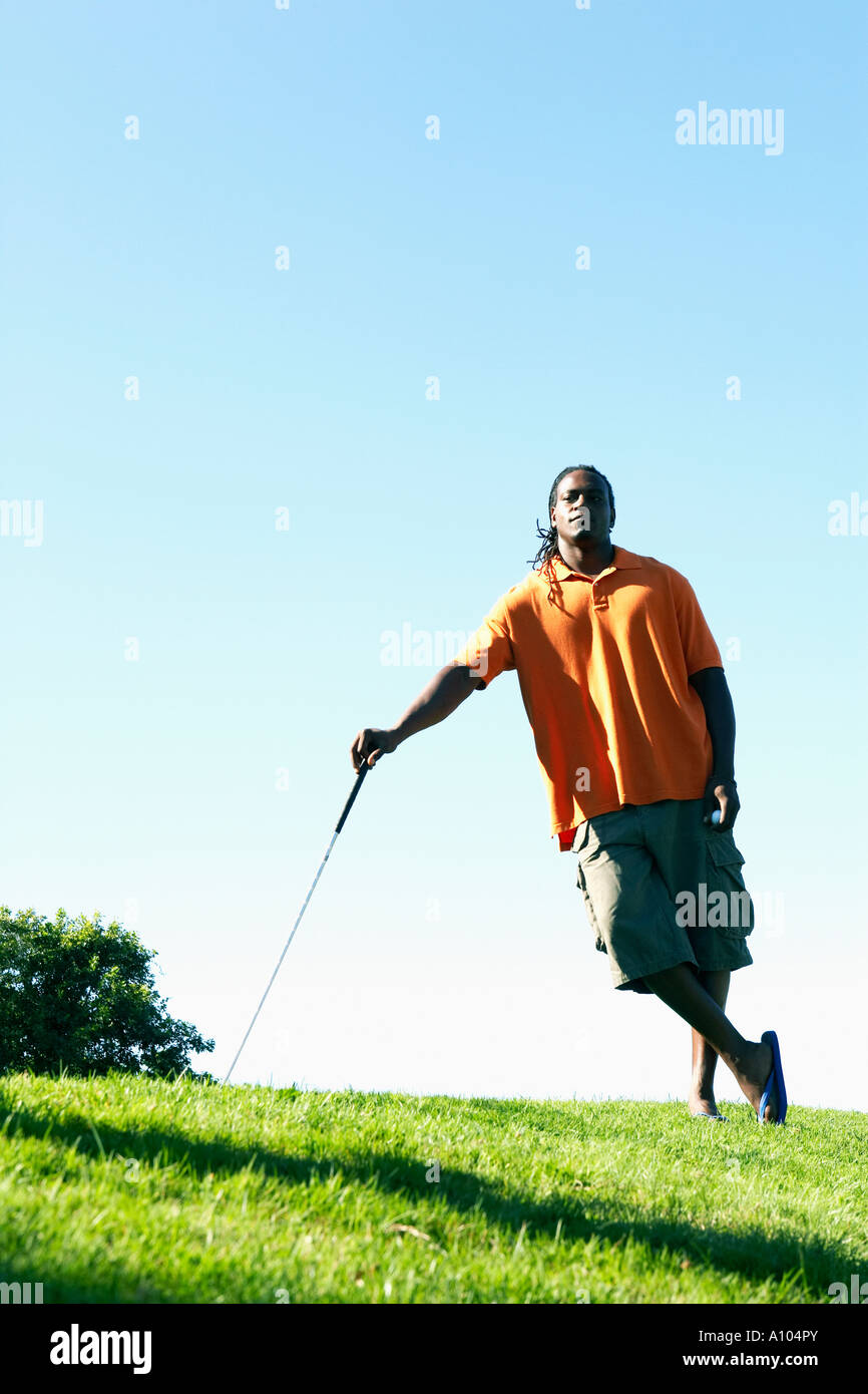 Young African man playing golf Stock Photo - Alamy
