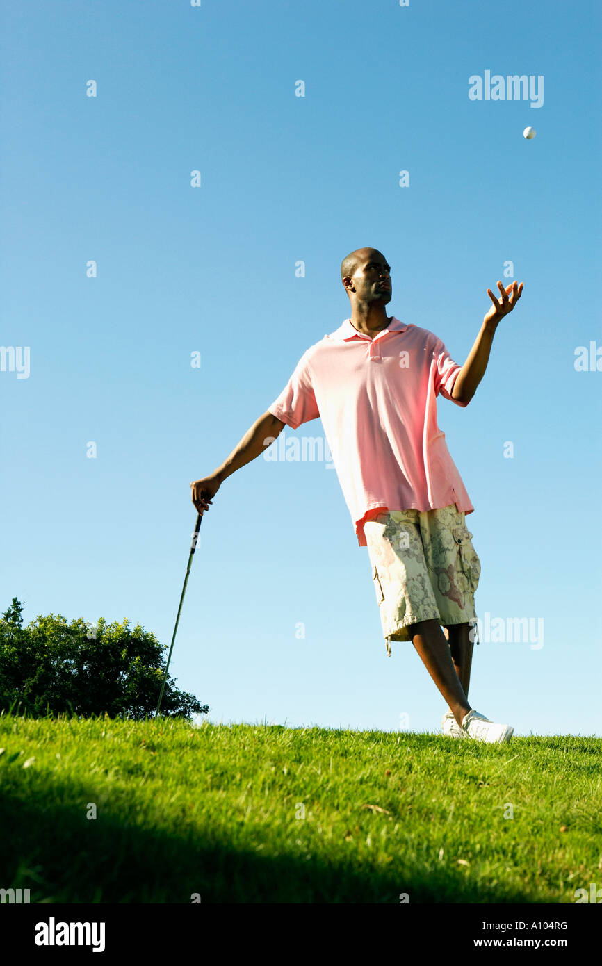 Young African man playing golf Stock Photo - Alamy