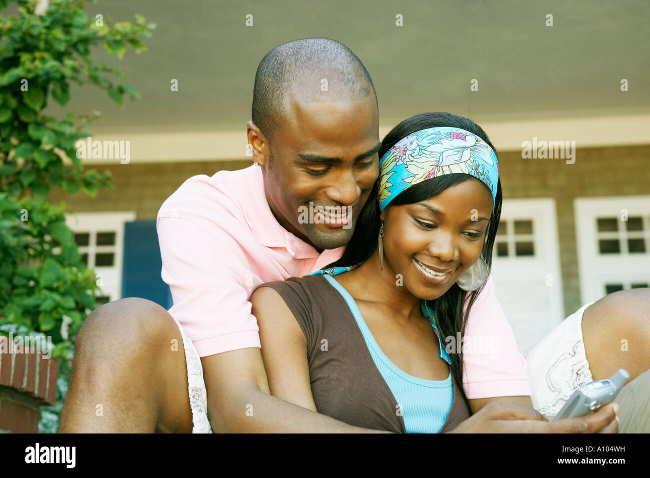 Young African couple hugging Stock Photo - Alamy