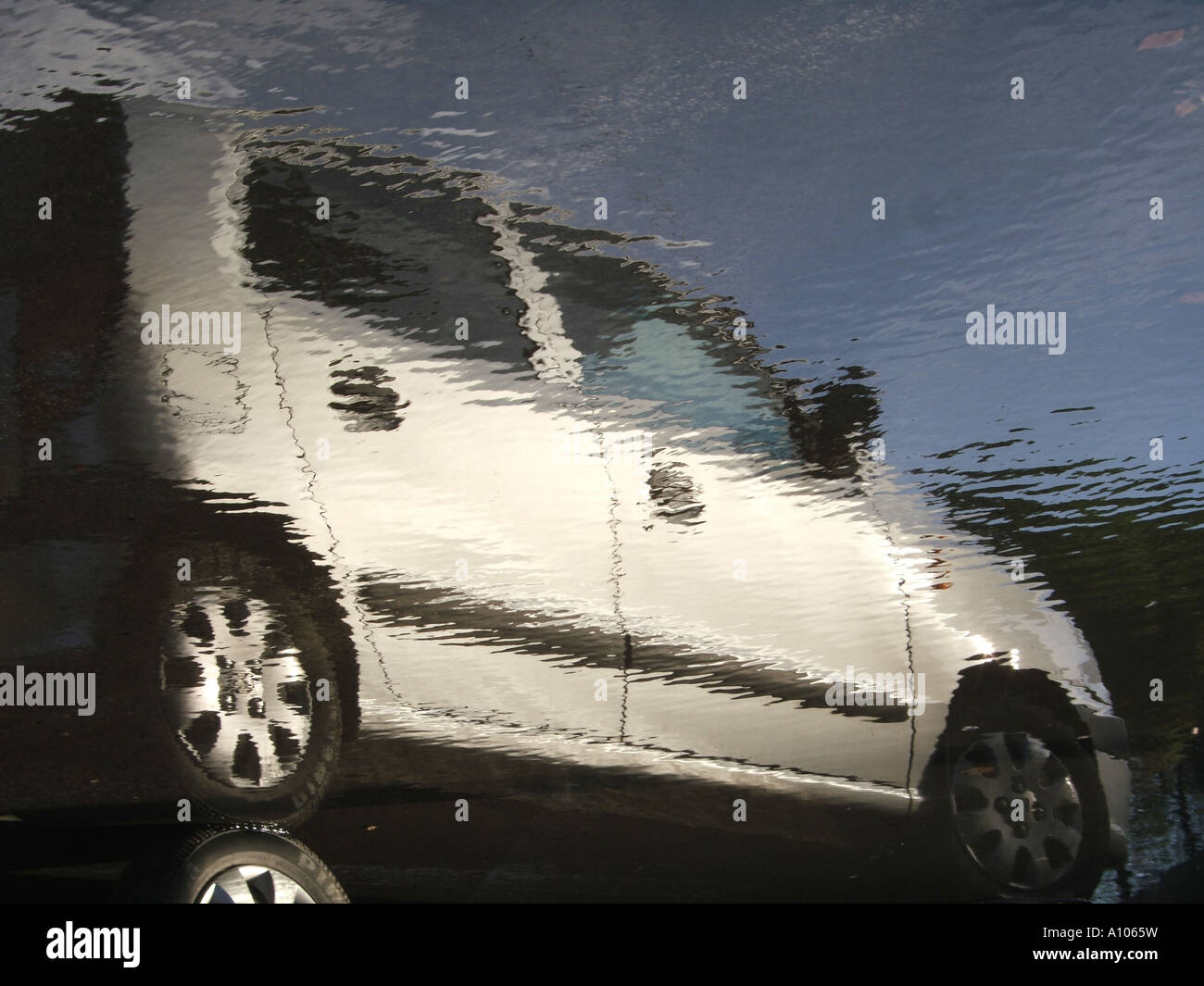 silver parked car reflection on flooded road Stock Photo - Alamy