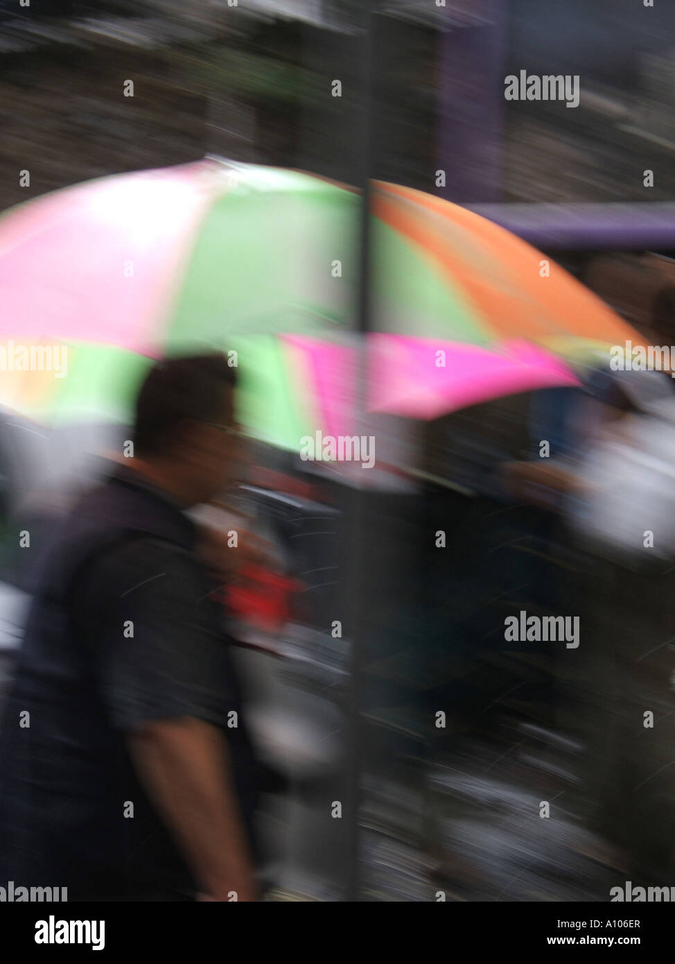person carrying umbrella in town Stock Photo - Alamy