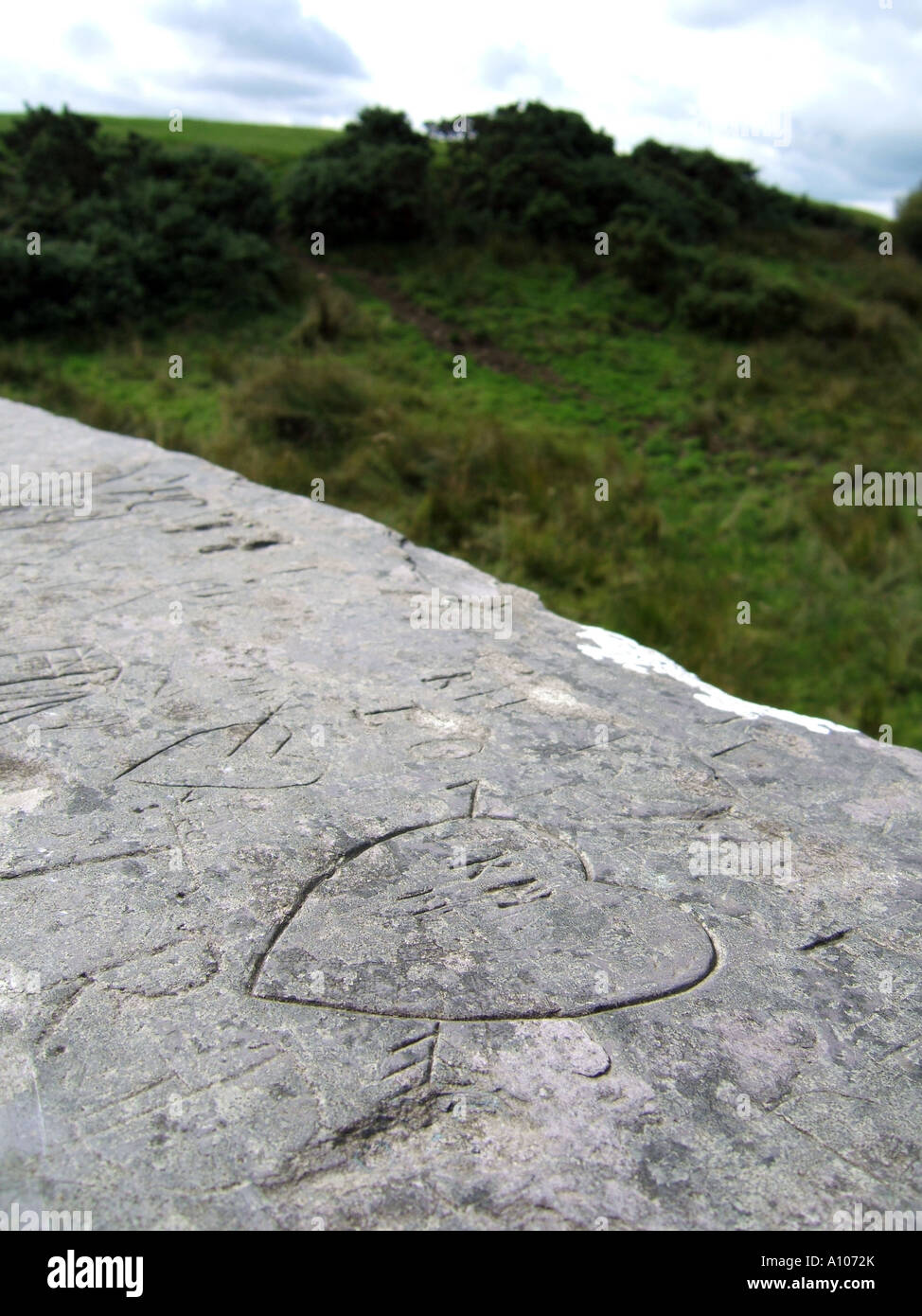 rc carved in heart with arrow on slate wall Stock Photo - Alamy