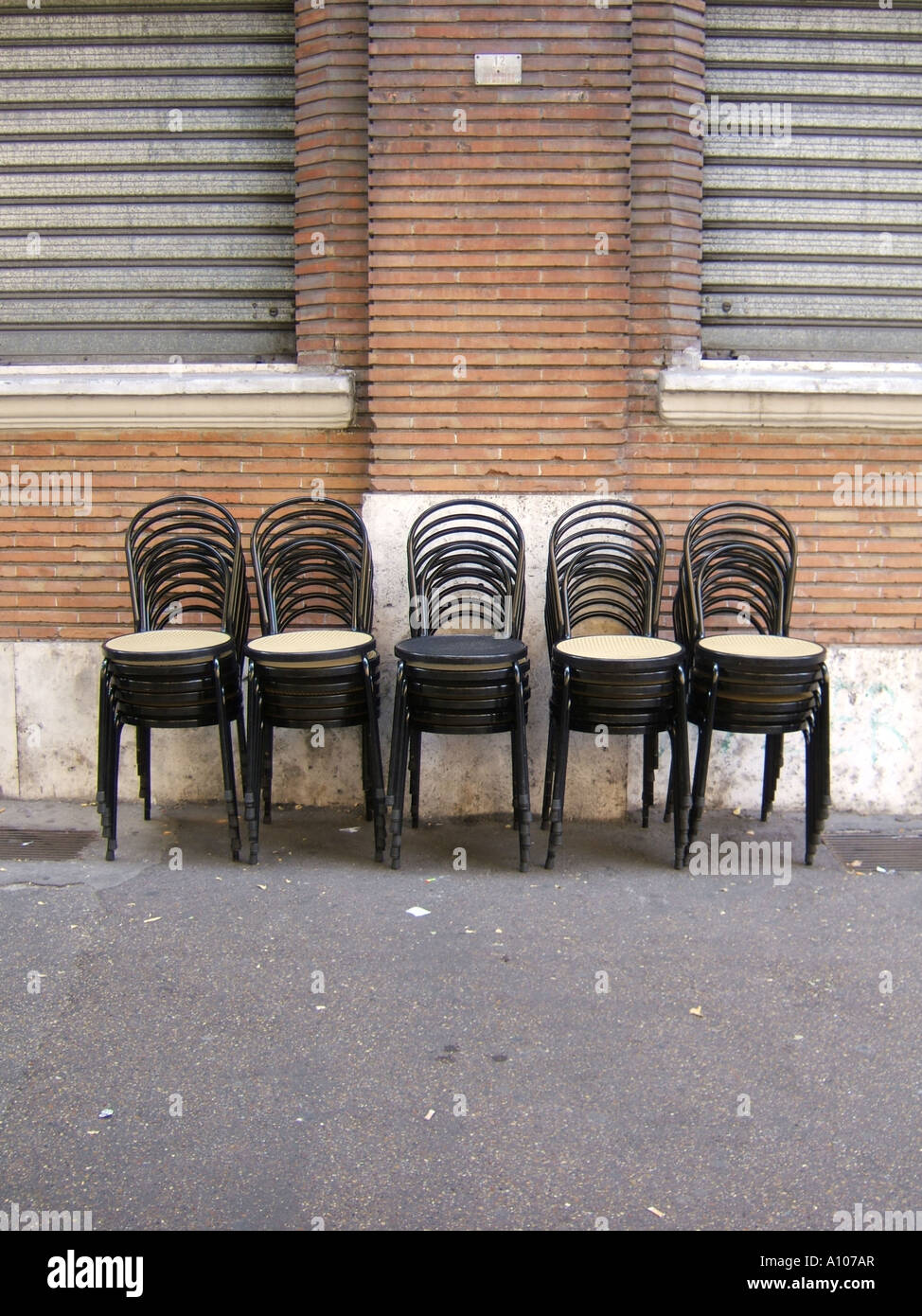 row of chairs on street in city Stock Photo - Alamy