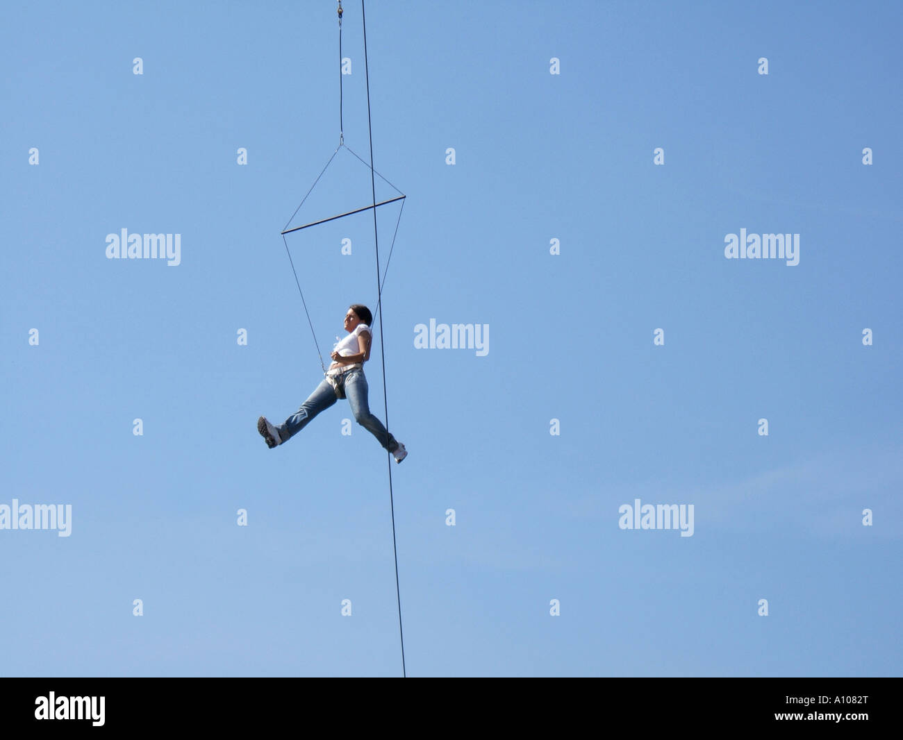 woman entertainer trapeze artist hanging on high wire rope Stock Photo ...