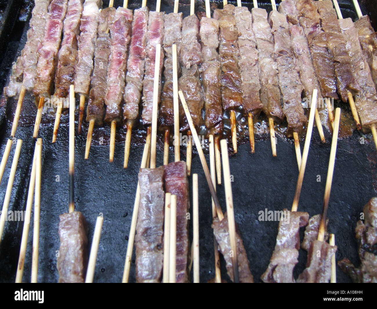 skewered meat cooked on grill Stock Photo - Alamy