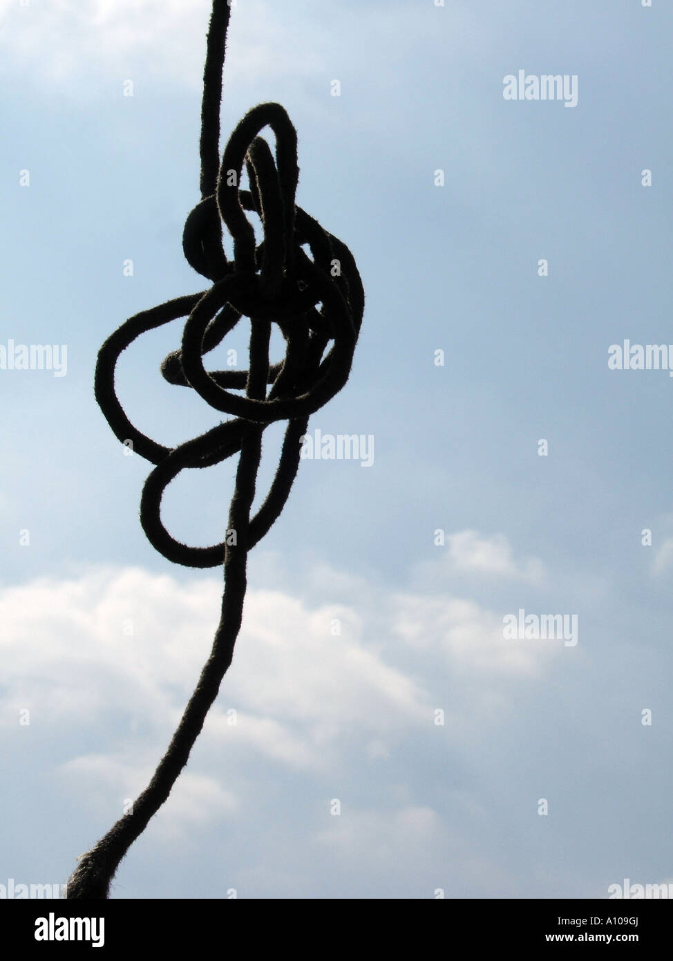 piece of rope hanging against blue sky Stock Photo - Alamy