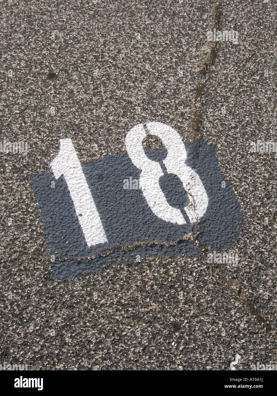 number eighteen painted on road surface Stock Photo - Alamy