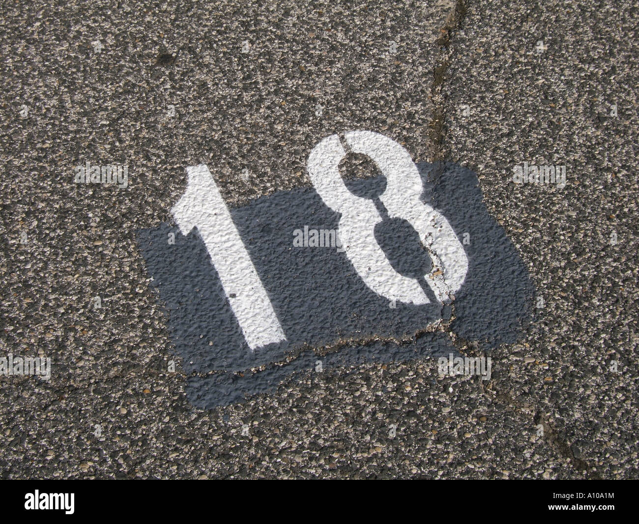 number eighteen painted on road surface Stock Photo - Alamy