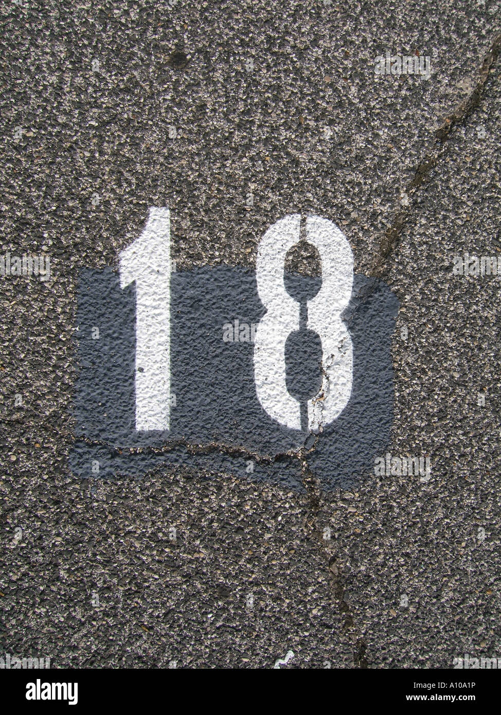 number eighteen painted on road surface Stock Photo - Alamy