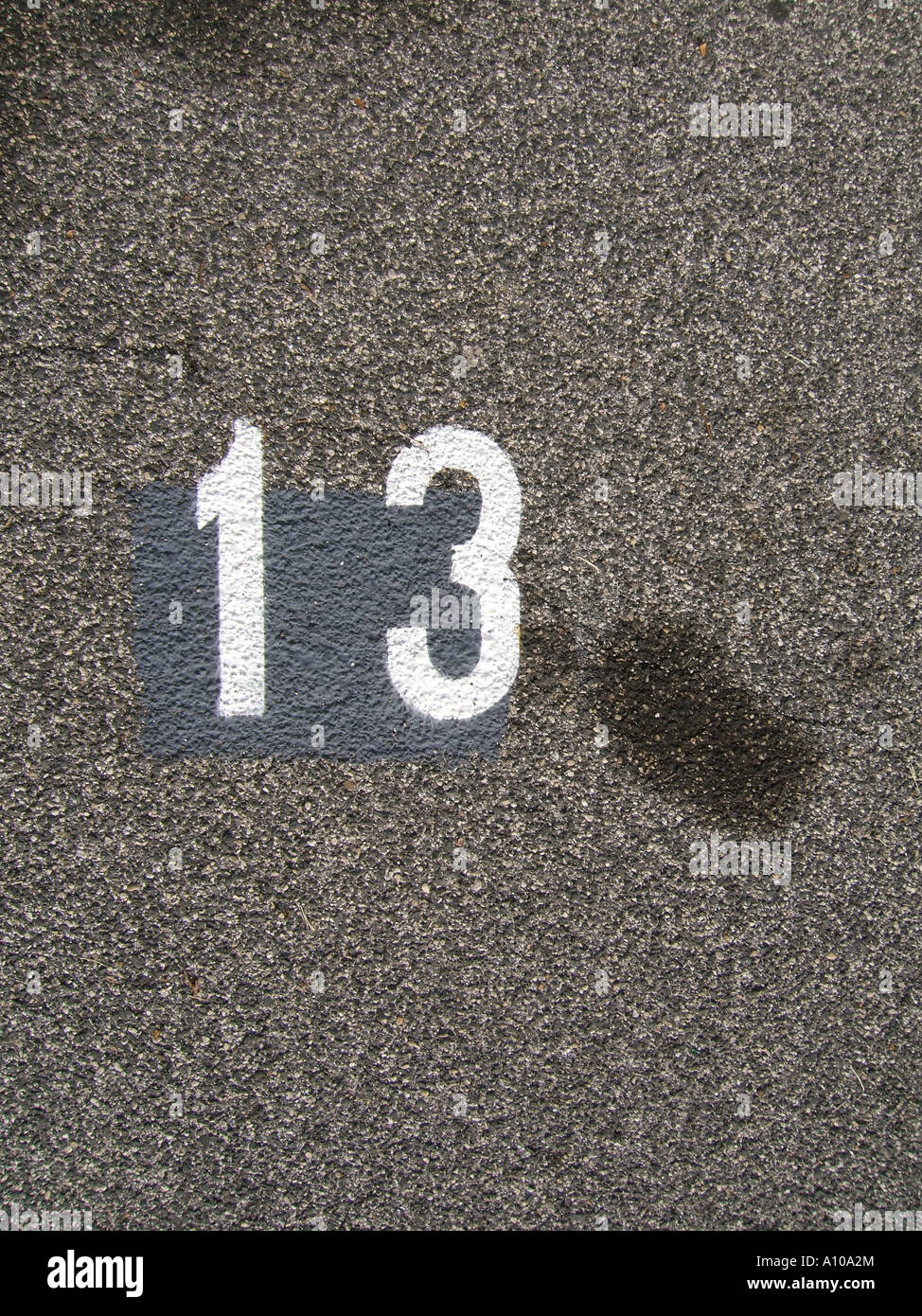 number thirteen painted on road surface Stock Photo - Alamy