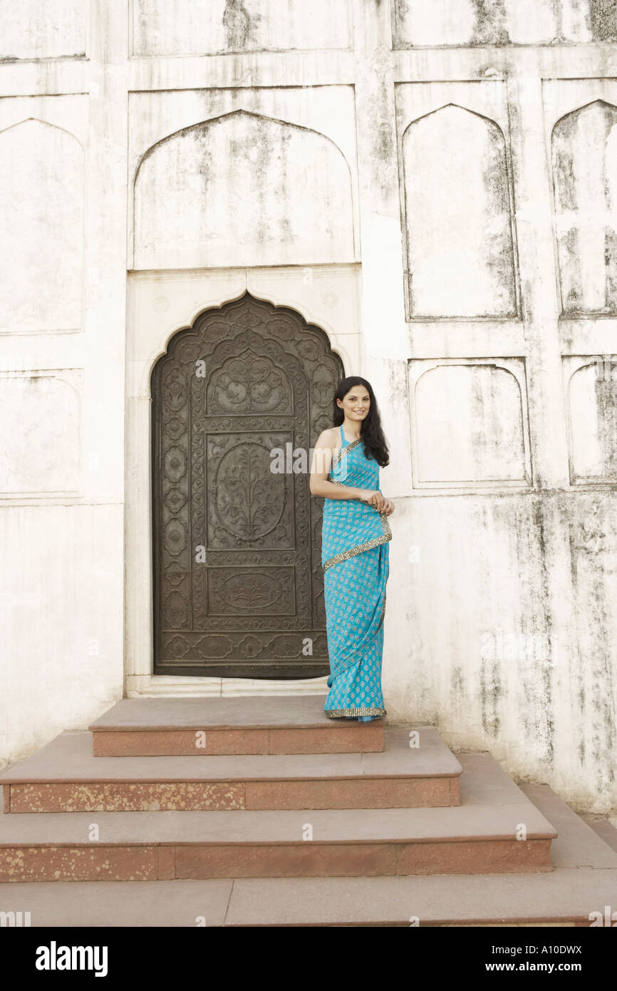 Portrait of a young woman standing at the doorstep Stock Photo - Alamy
