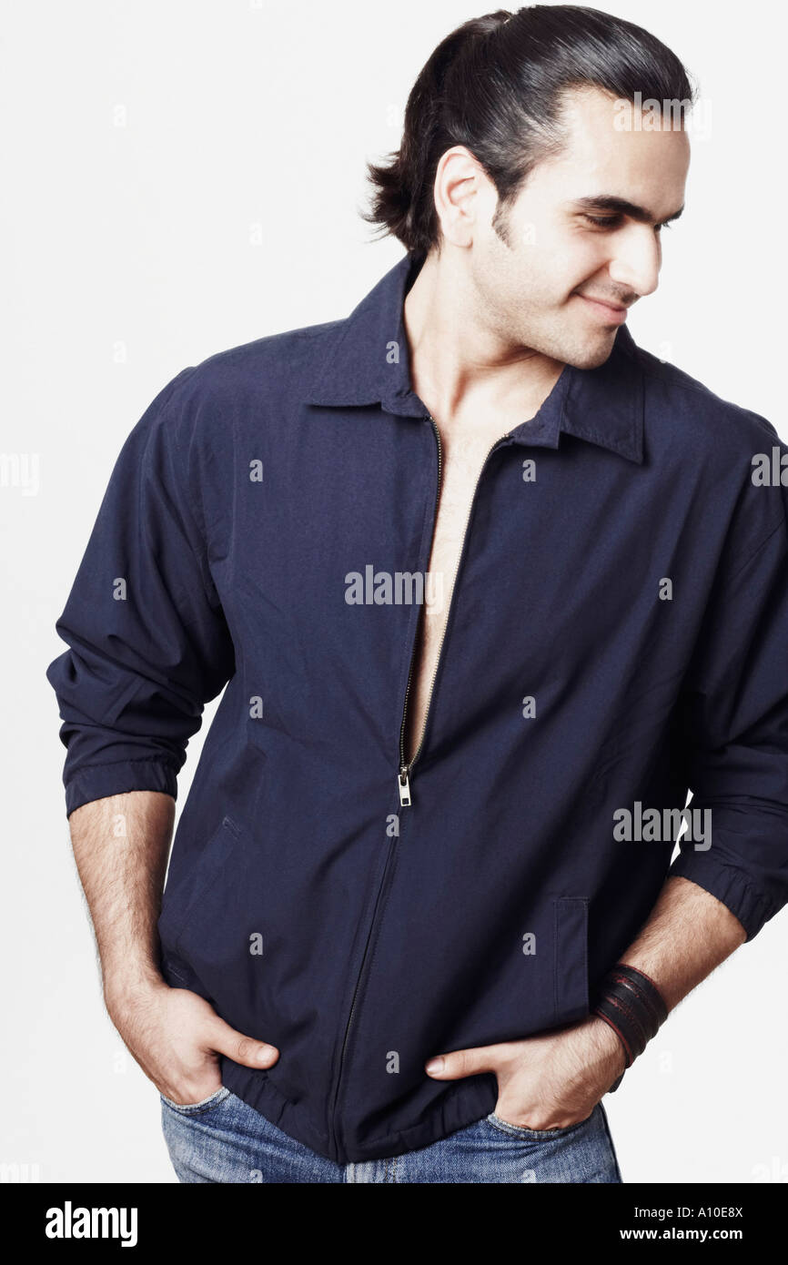 Close-up of a young man with his hands in his pockets Stock Photo - Alamy