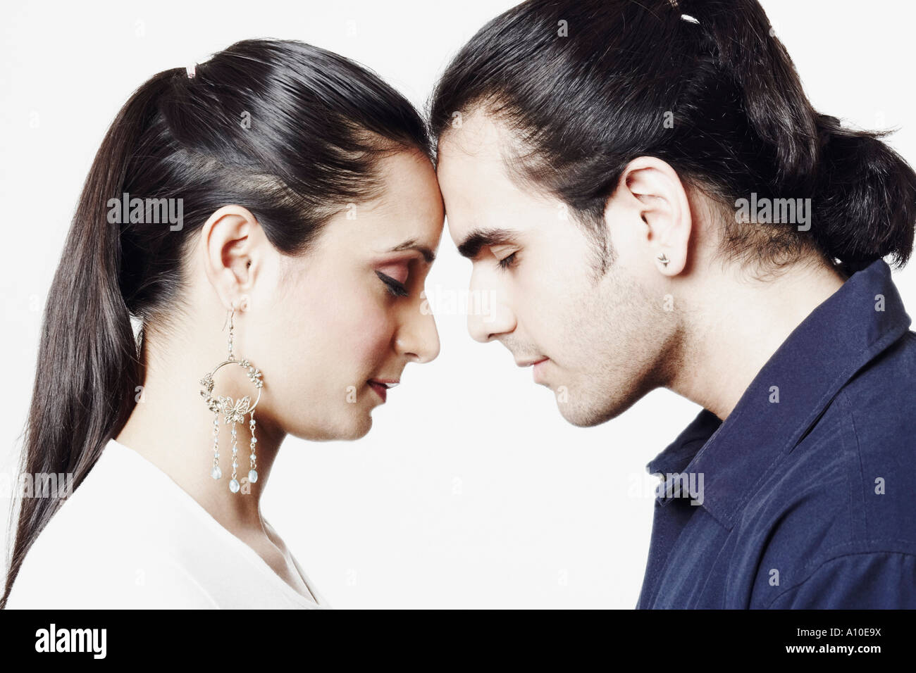 Side profile of a young couple facing each other with their eyes closed ...