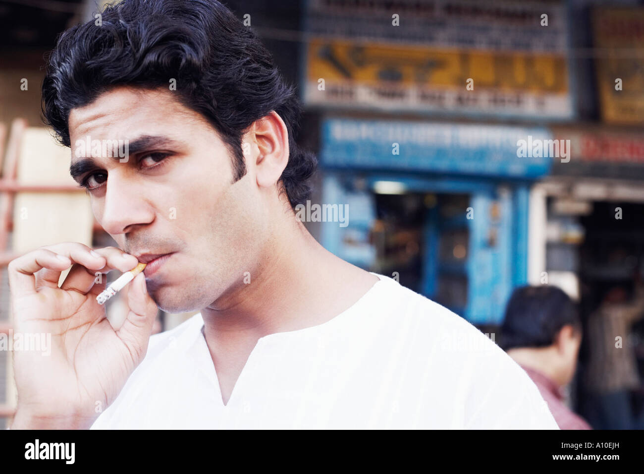 Portrait of a young man smoking a cigarette Stock Photo - Alamy