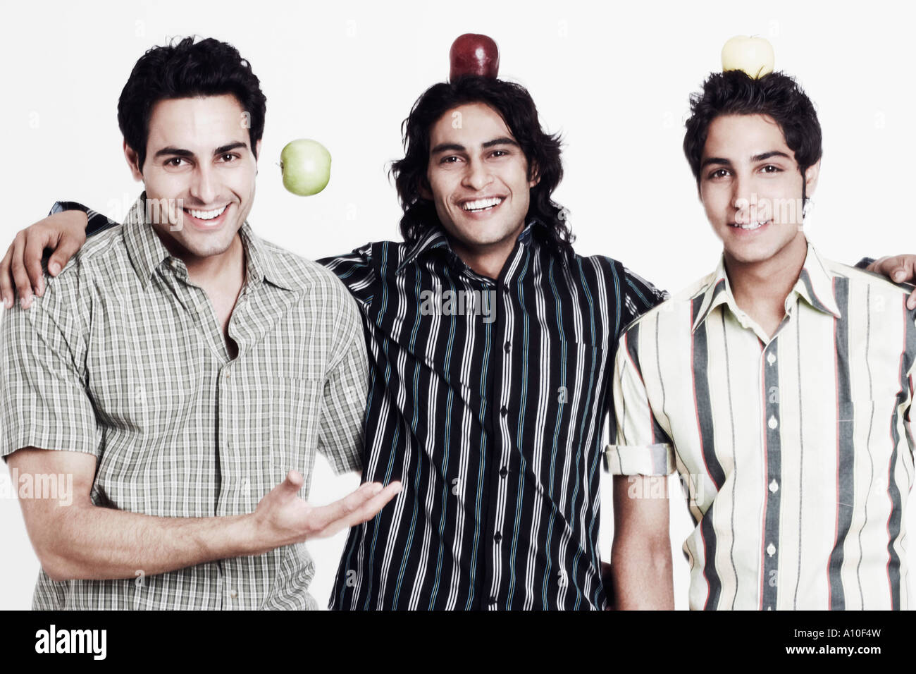 Portrait of three young men smiling Stock Photo - Alamy