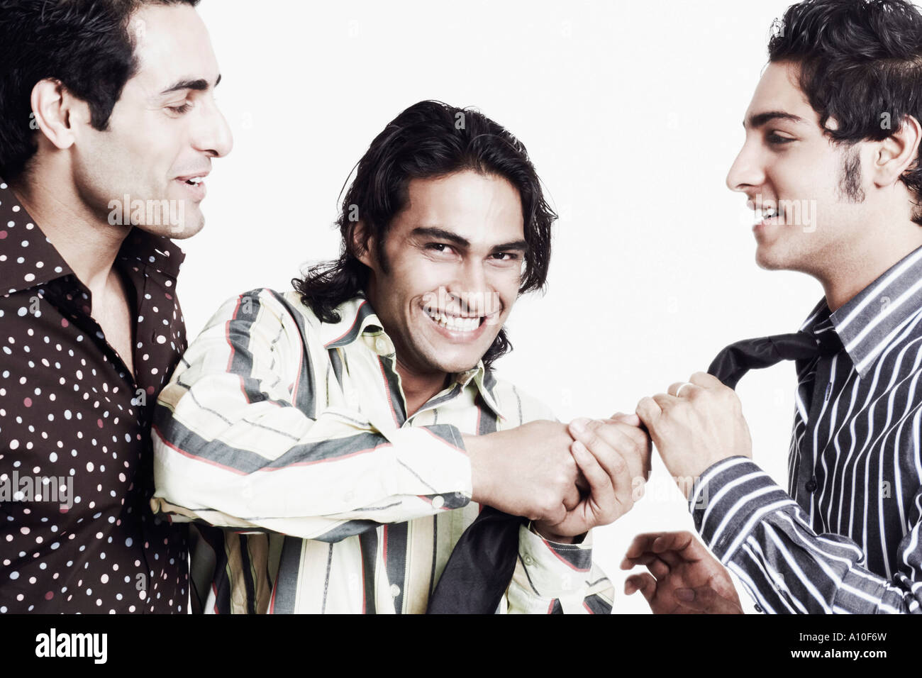 Three young men pulling hi-res stock photography and images - Alamy