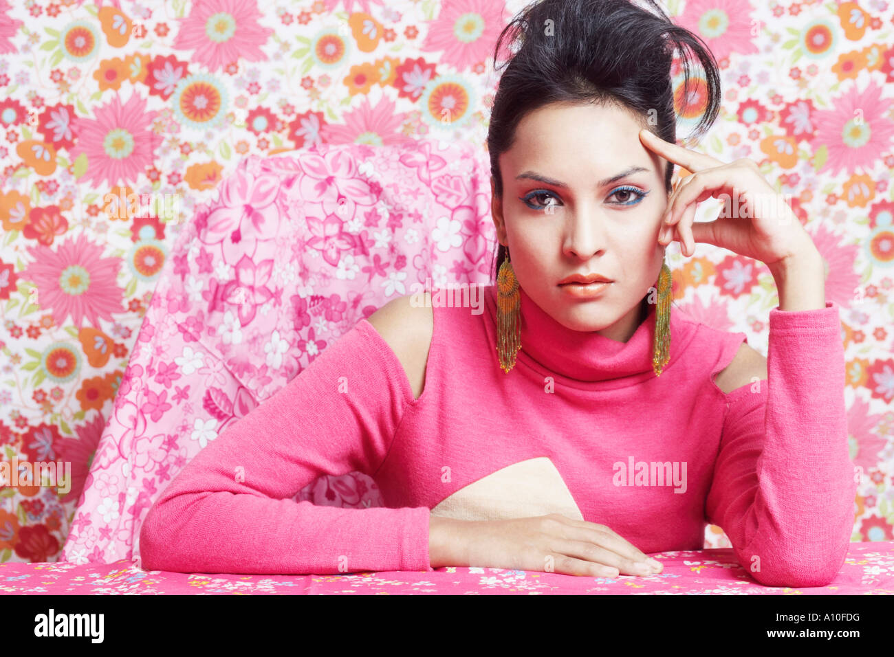Portrait of a young woman with her finger on head Stock Photo - Alamy