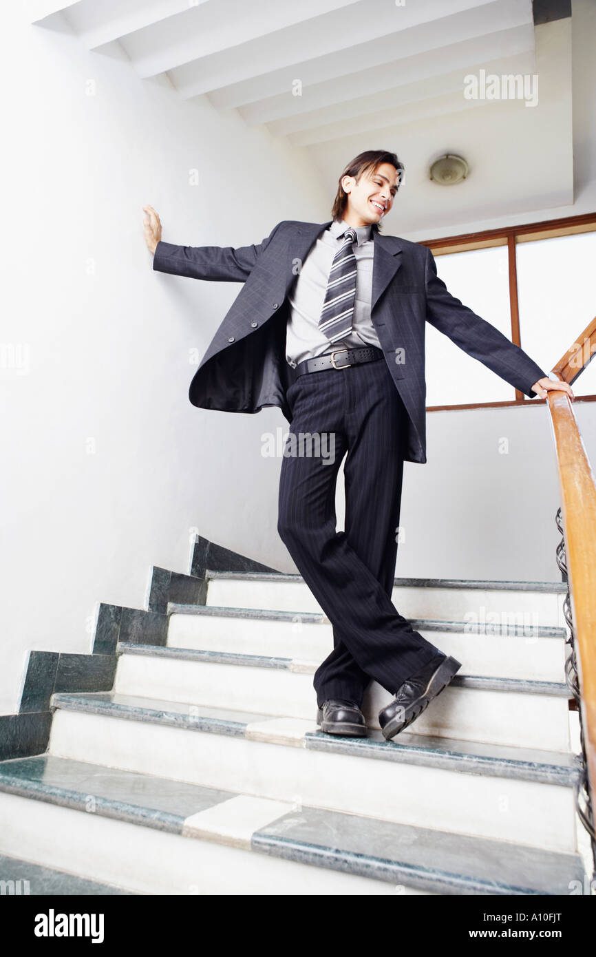 Indian businessman standing with his arm outstretched Stock Photo - Alamy