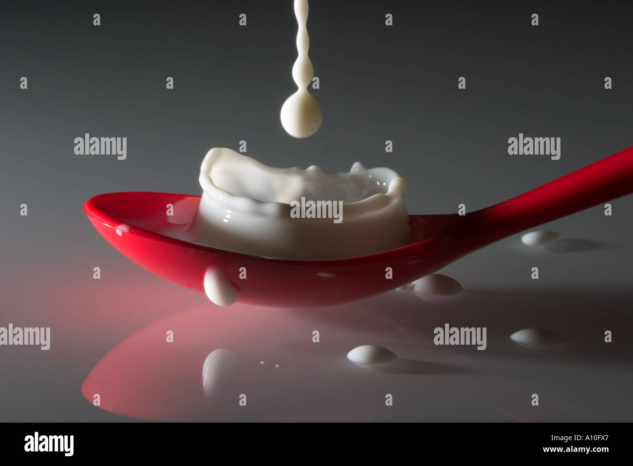 Milk splash on the spoon Stock Photo - Alamy