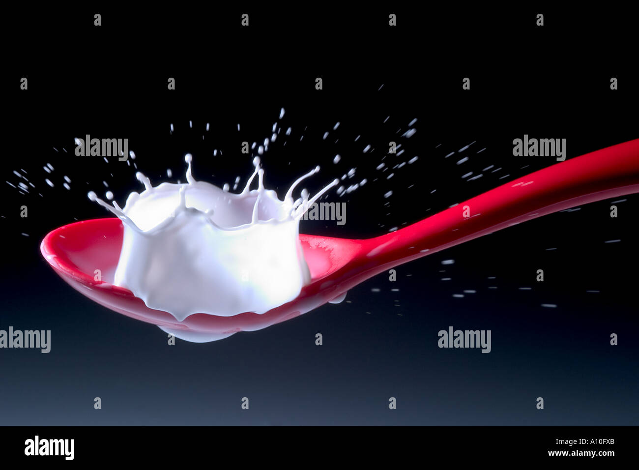 Milk splash on the spoon Stock Photo - Alamy