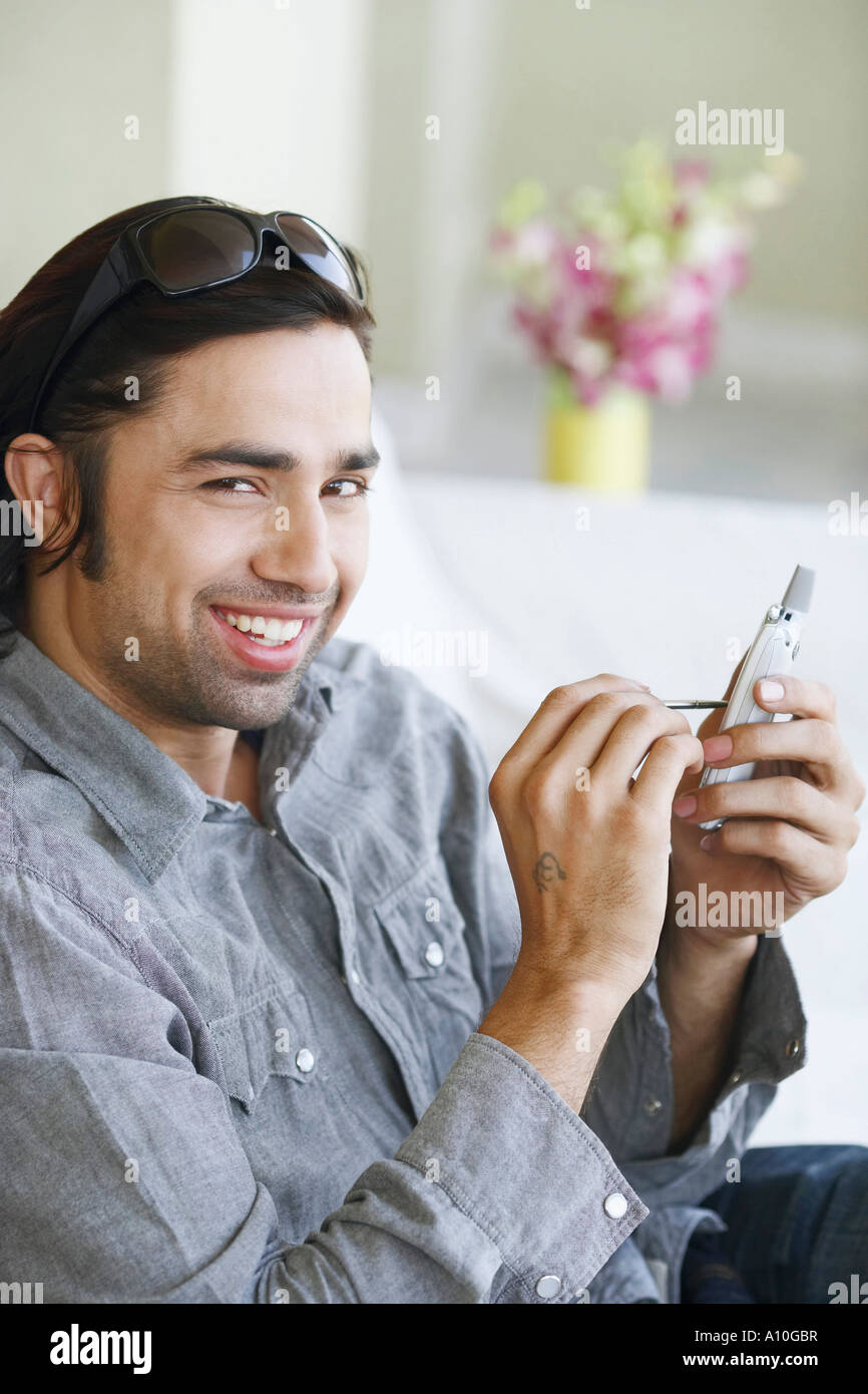 Portrait of a young man using a mobile phone with a digitized pen Stock ...