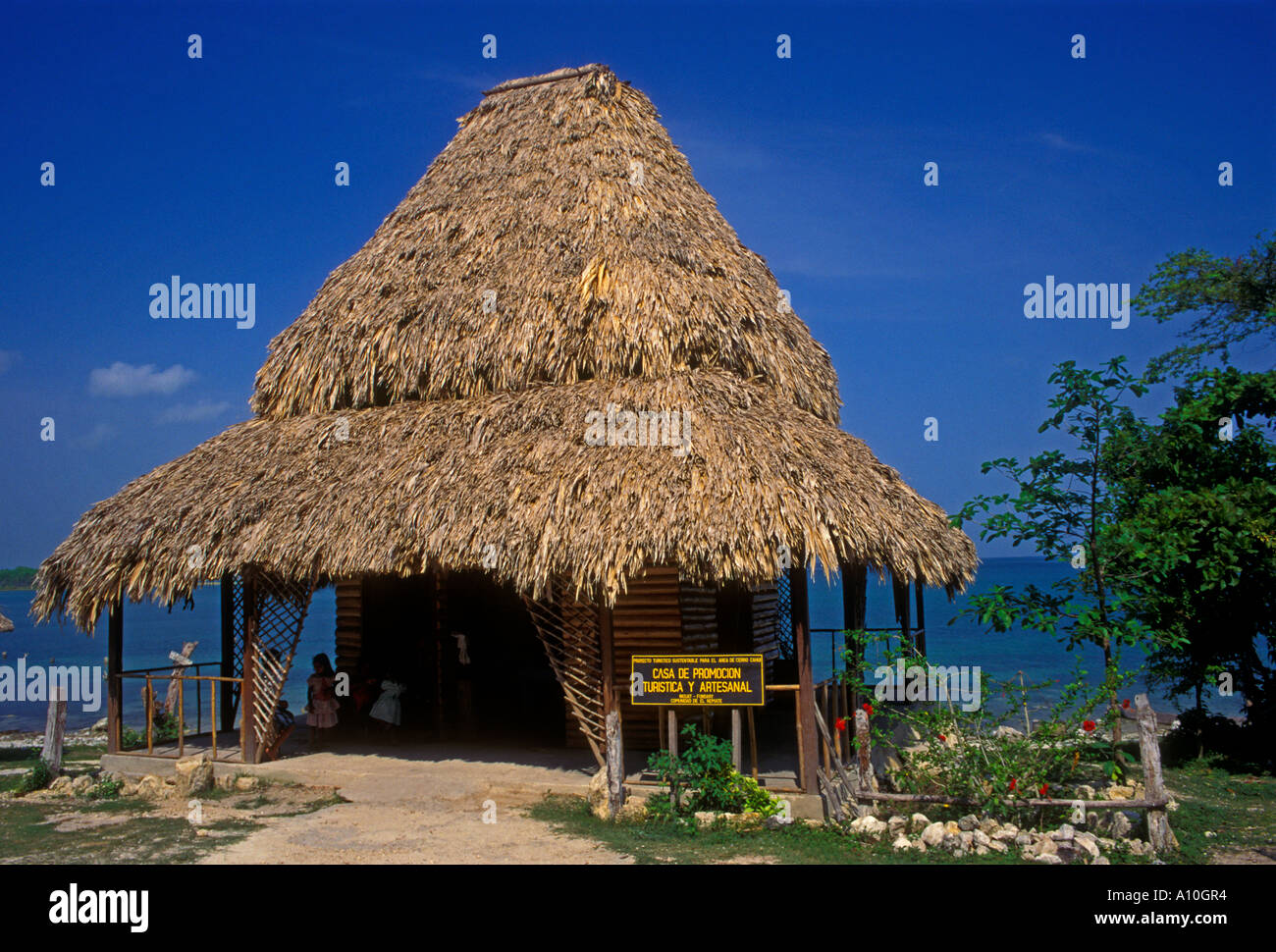 Sign for tourist information and crafts thatched roof building near ...