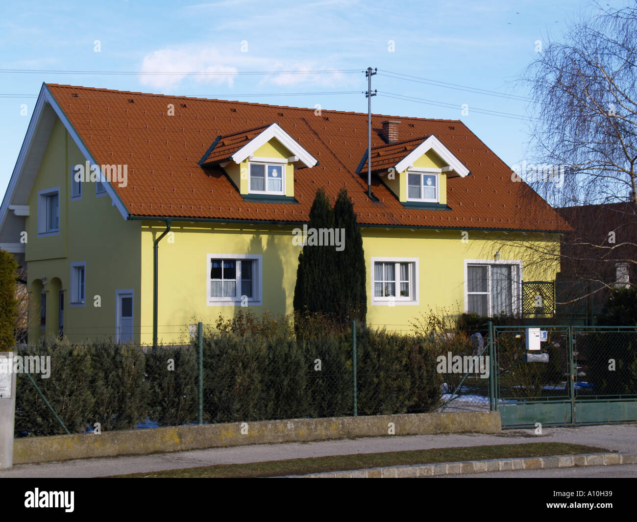 yellow one-family house with red brick roof Stock Photo - Alamy