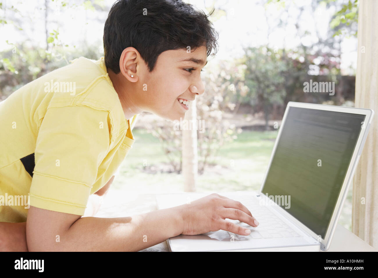 Boy operating laptop hi-res stock photography and images - Alamy
