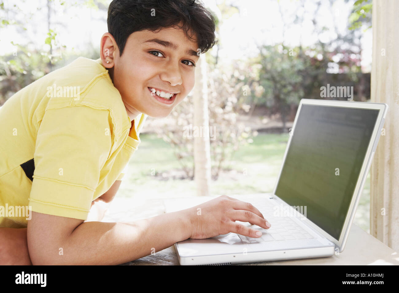 Boy operating laptop hi-res stock photography and images - Alamy