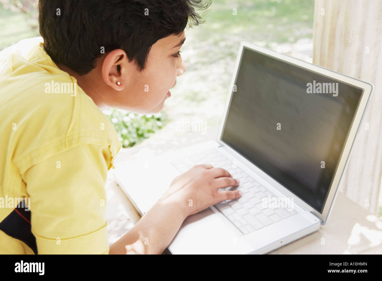 Boy operating laptop hi-res stock photography and images - Alamy
