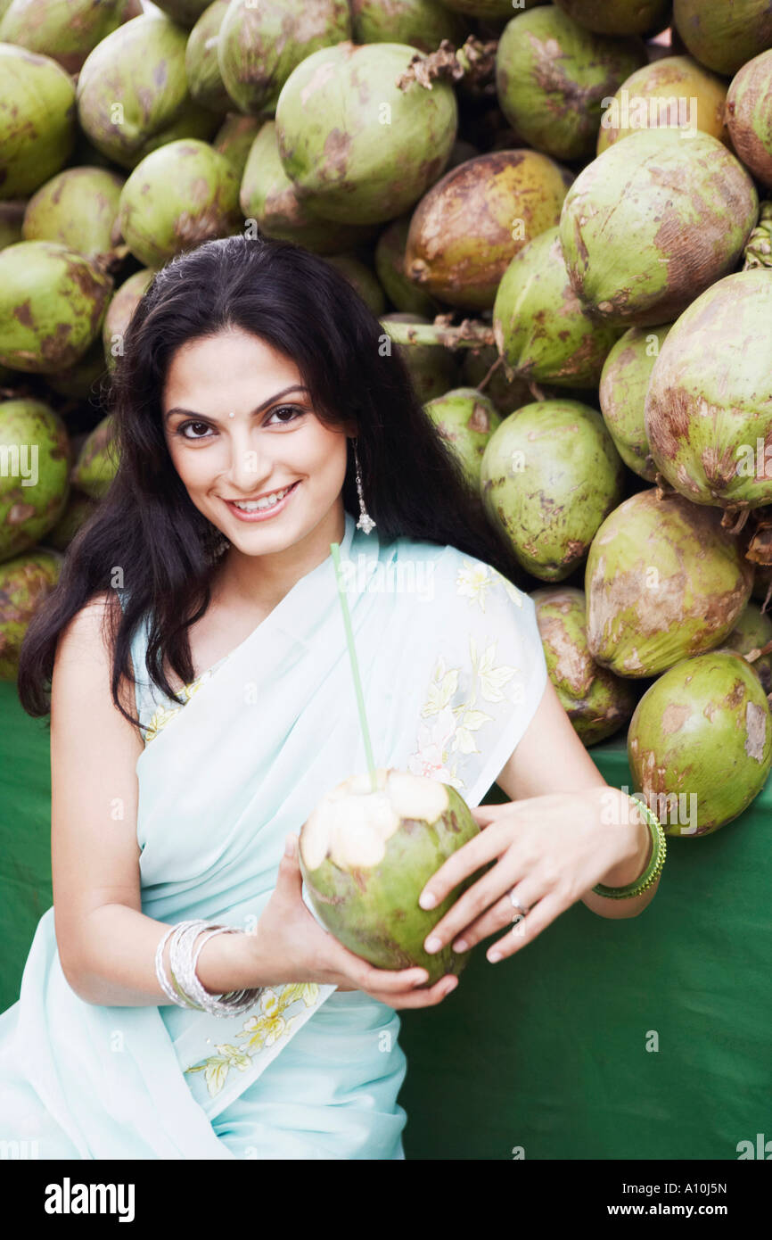 Woman drink coconut looking at camera hi-res stock photography and ...