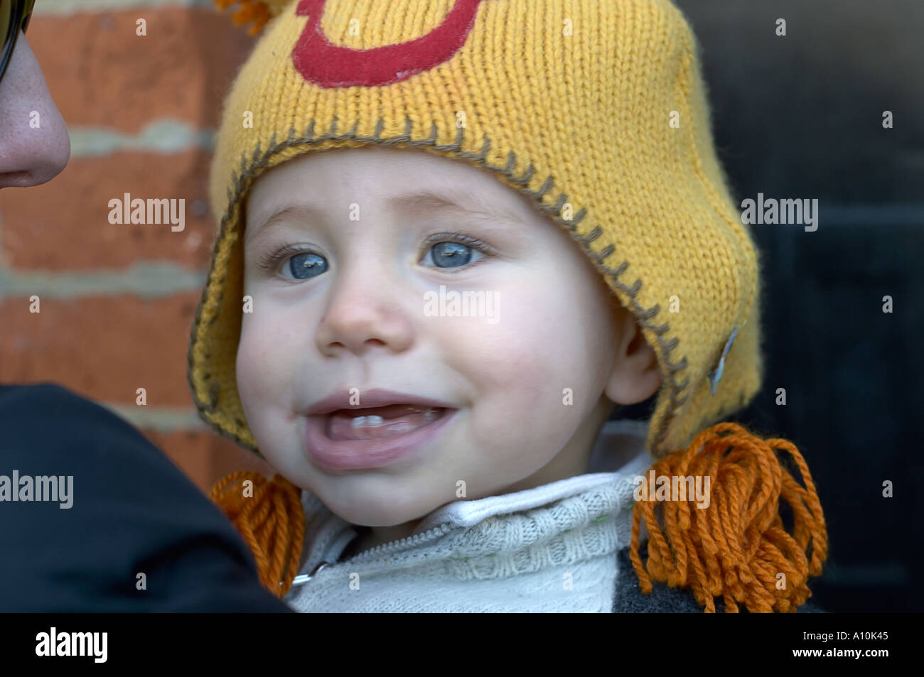 Toddler in hat held by mother Model released and Property released ...