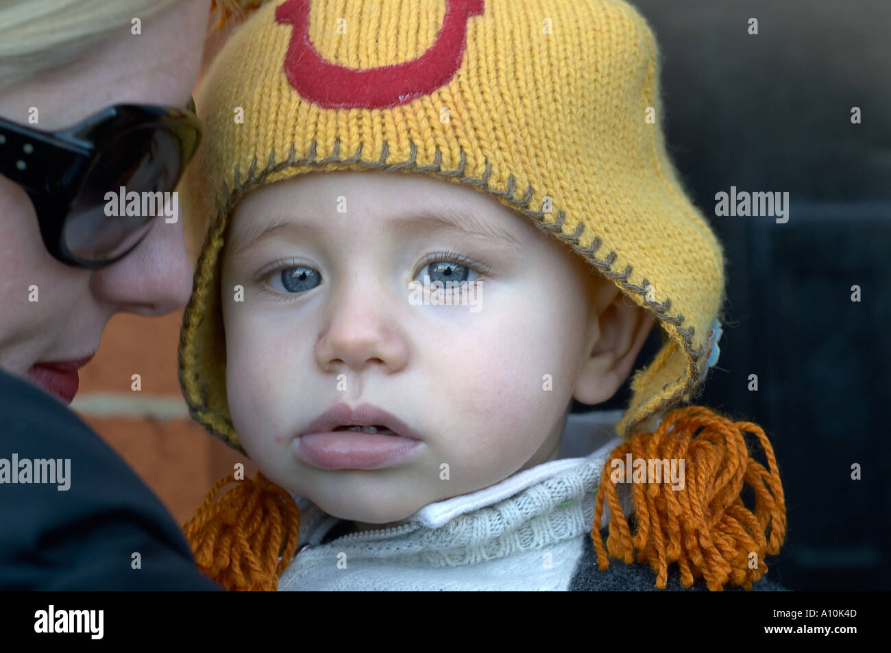 Toddler in hat held by mother Model released and Property released ...